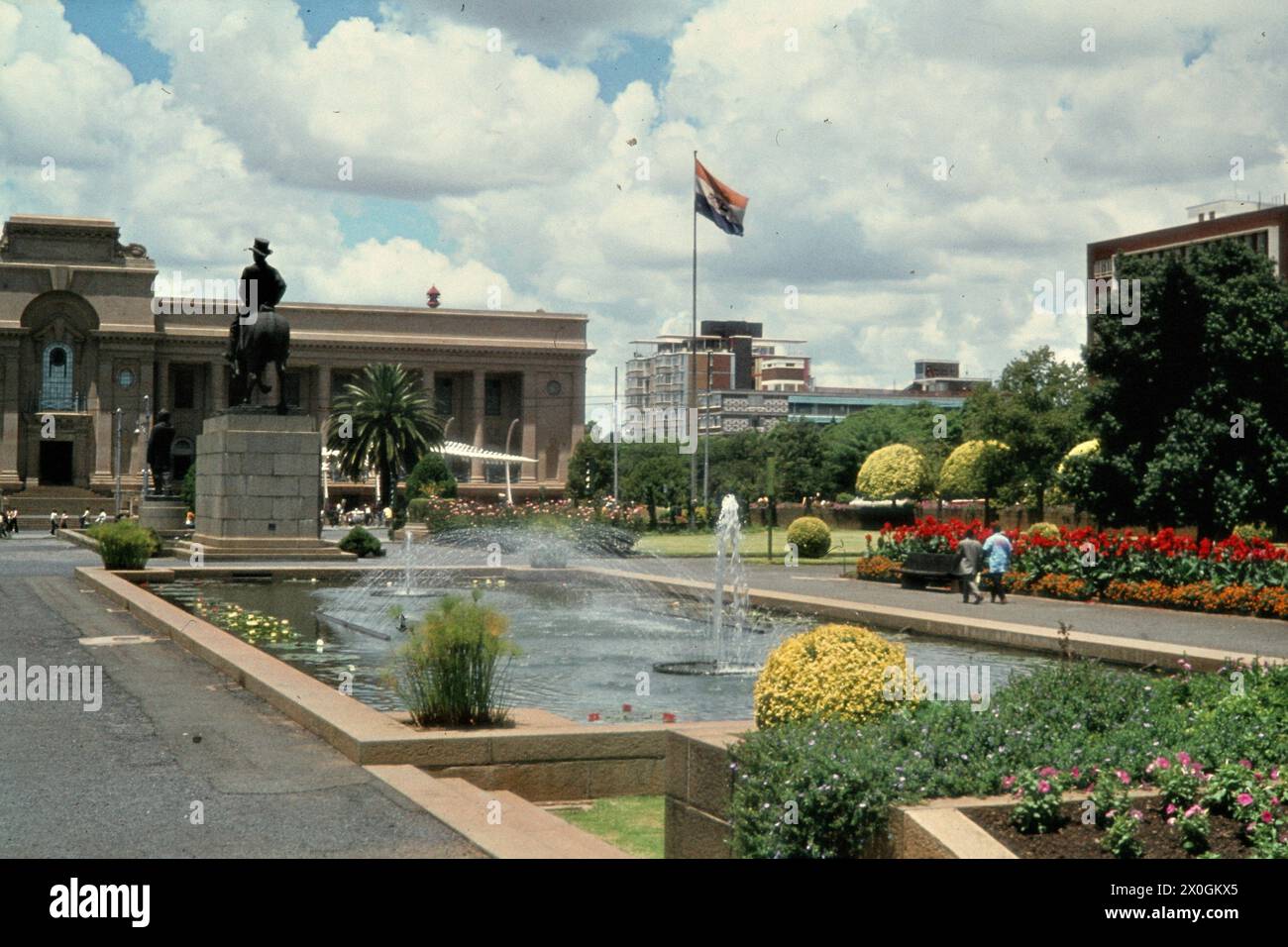 The South African flag and an equestrian statue on Pretorius Square in ...