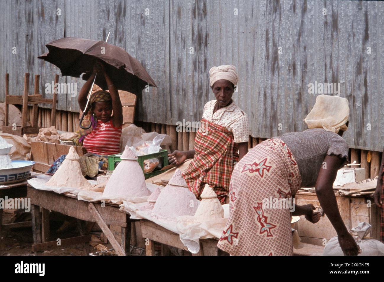 Women sell products on a market square in the Rwandan capital of Kigali ...