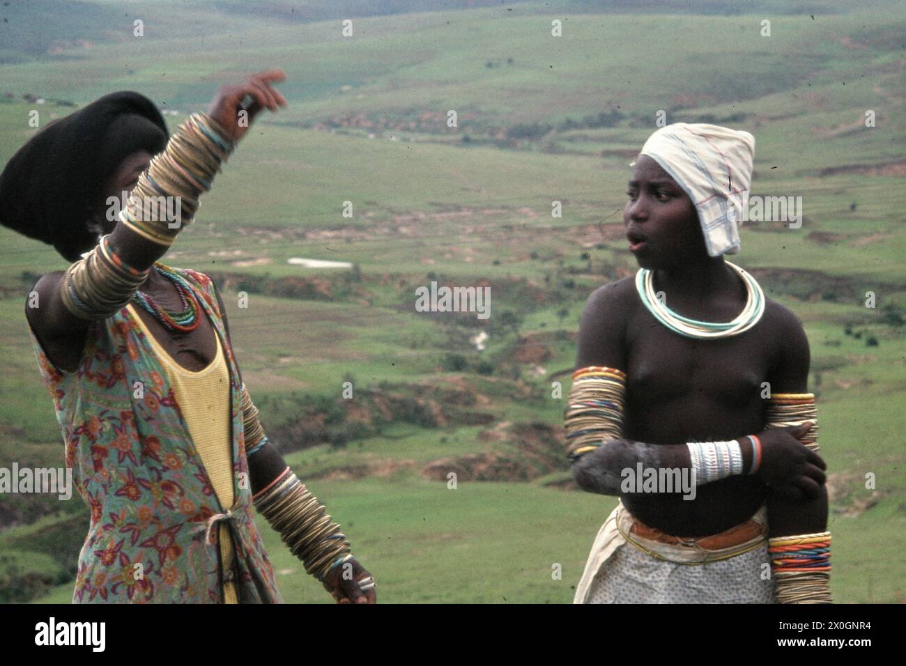 Girl from the Xhosa ethnic group with chains on her arms in front of ...