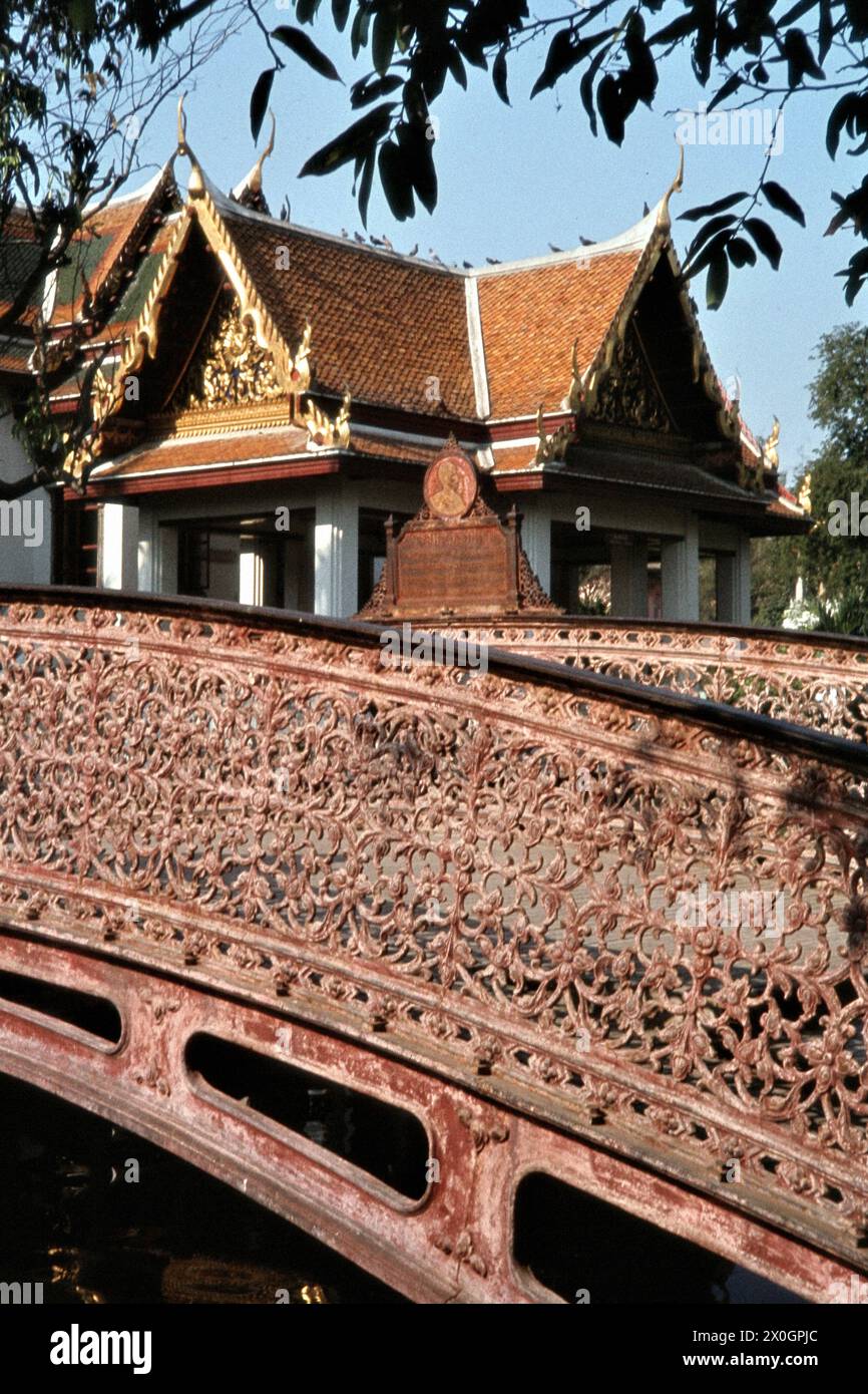 A bridge with heavily decorated terrain leads to a temple in Bangkok ...