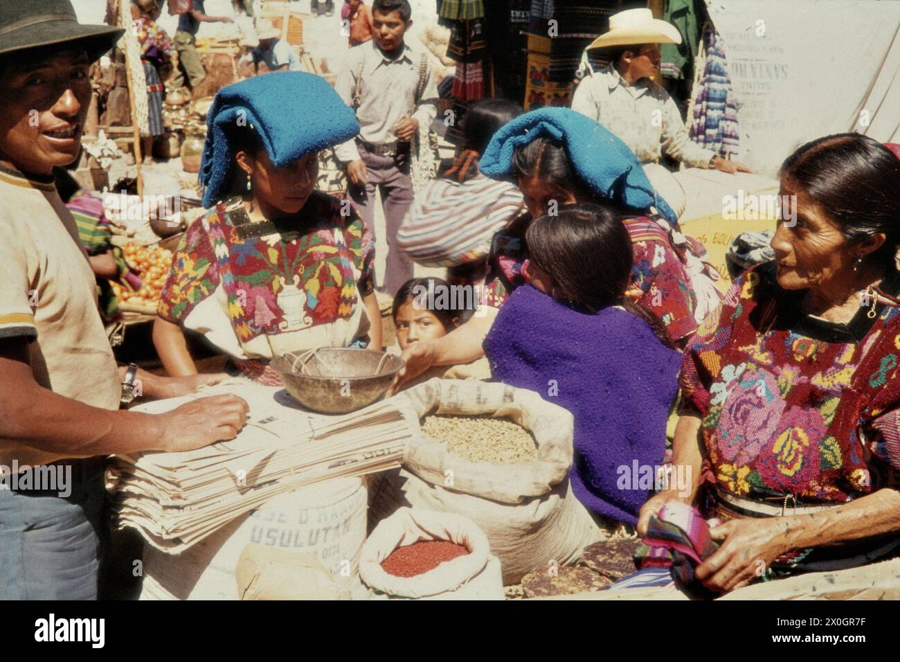 Women in traditional costume sell spices at a market place in ...