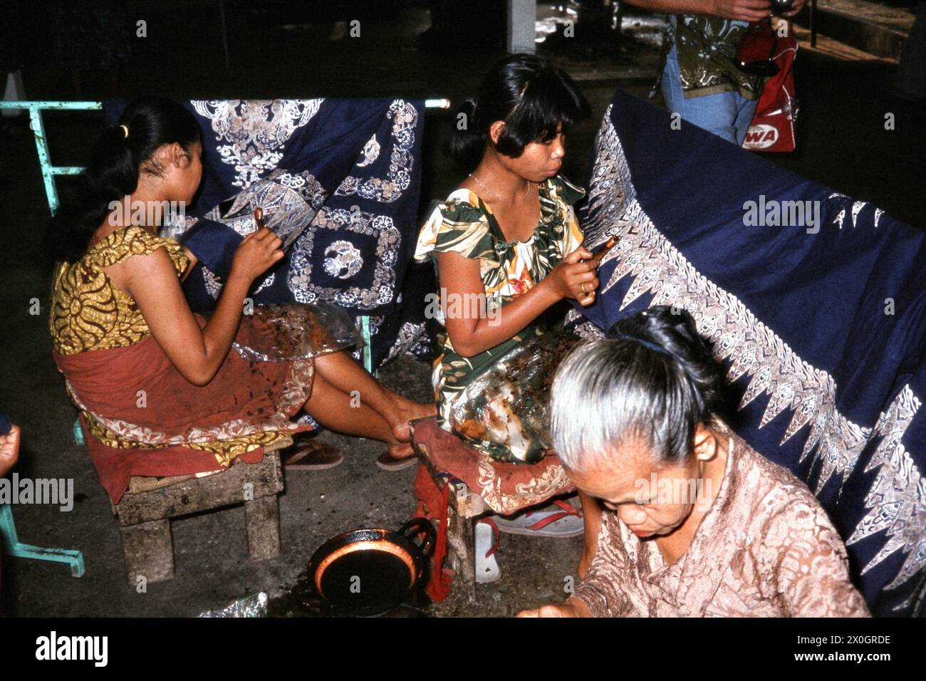 Women decorate blue-colored textiles in a dye shop in Yogyakarta Stock ...