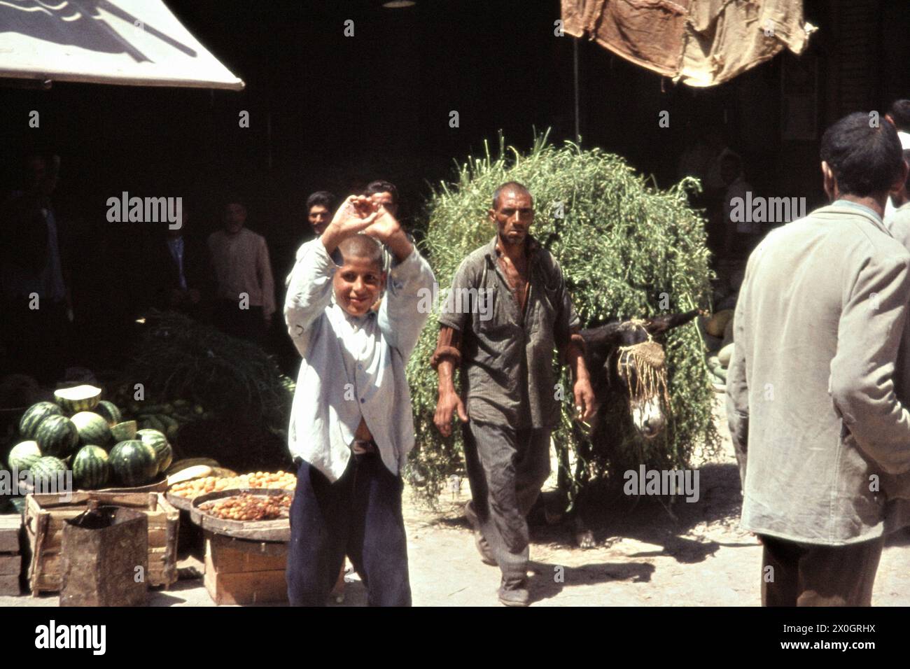 A loaded donkey is led over a bazaar in Mianeh (Meyaneh). [automated ...