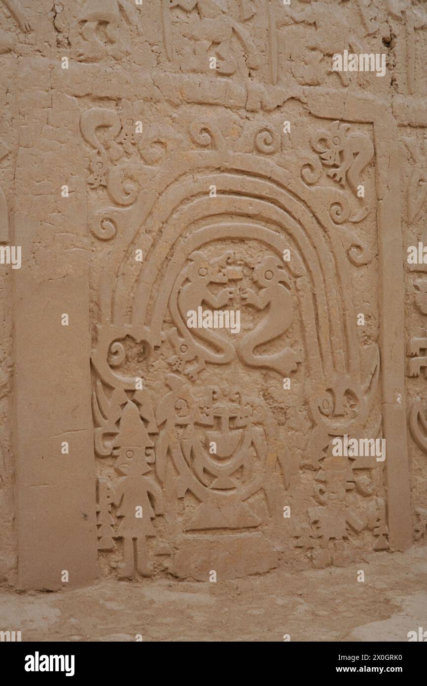 Detail of a relief with priest with staff in his hand and rainbow in a ...