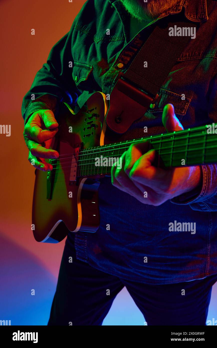 Cropped photo of elderly man guitarist performing chords of rock-ballad ...