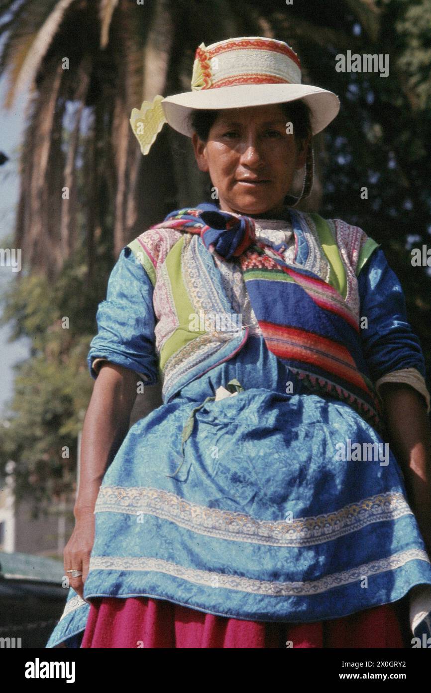 A woman in traditional Peruvian costume with hat in Tacna. [automated ...