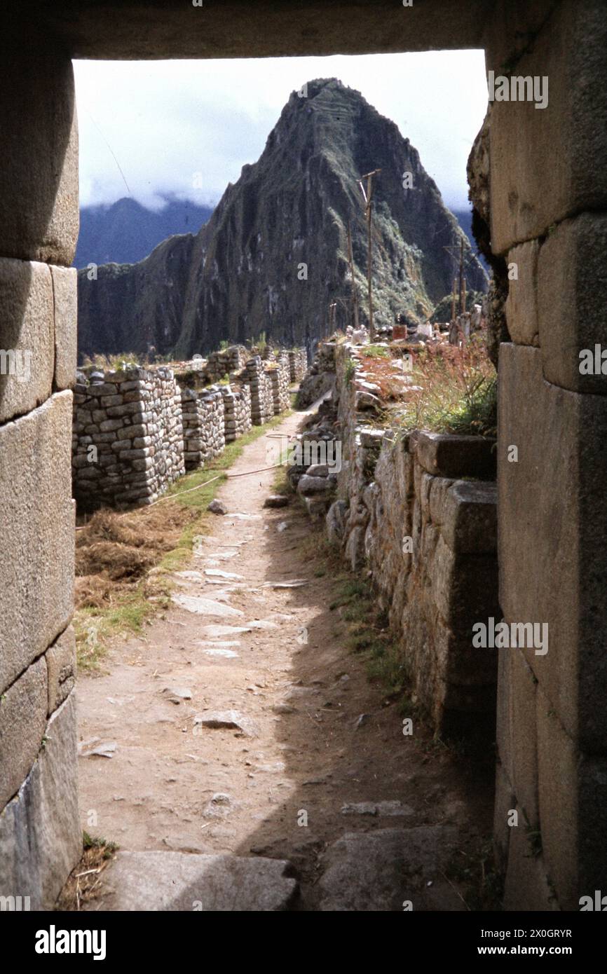 View through the main gate of the ruined city Machu Picchu to the ...