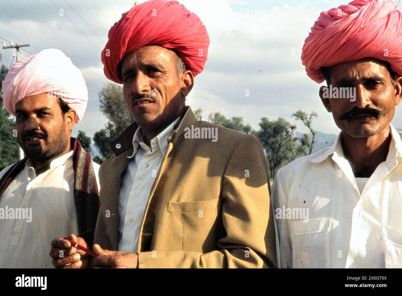 Three men with red turbans on a street in Sadri. [automated translation ...