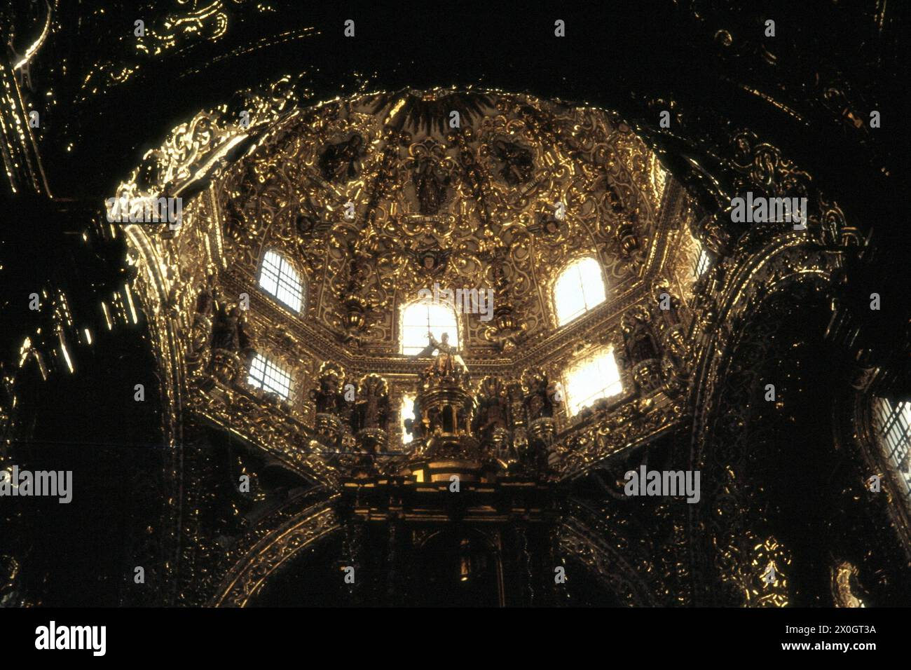 The gilded interior of the dome of the 17th century Santo Domingo ...