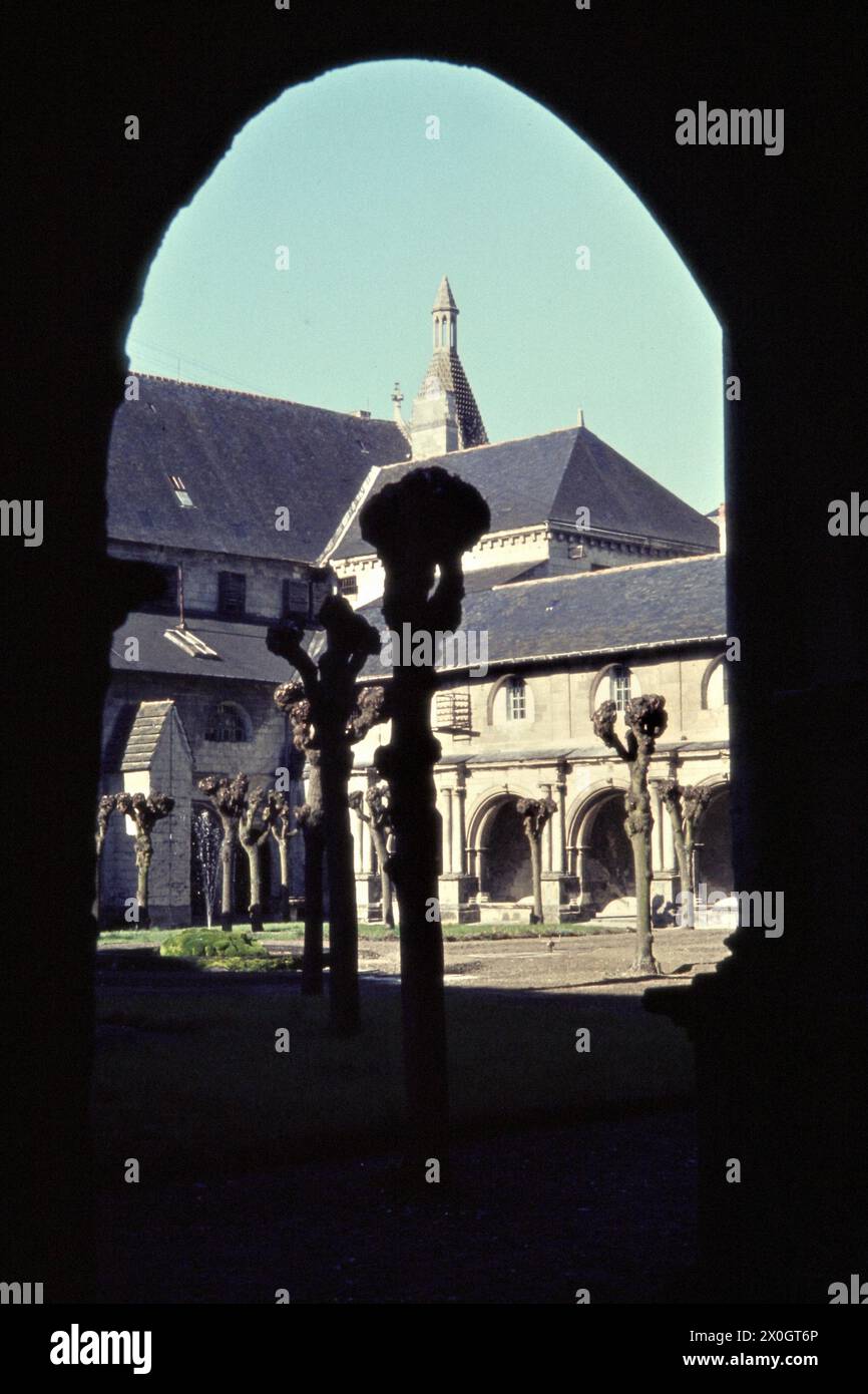 View through a gate to the courtyard of the Fontevrault Abbey in ...