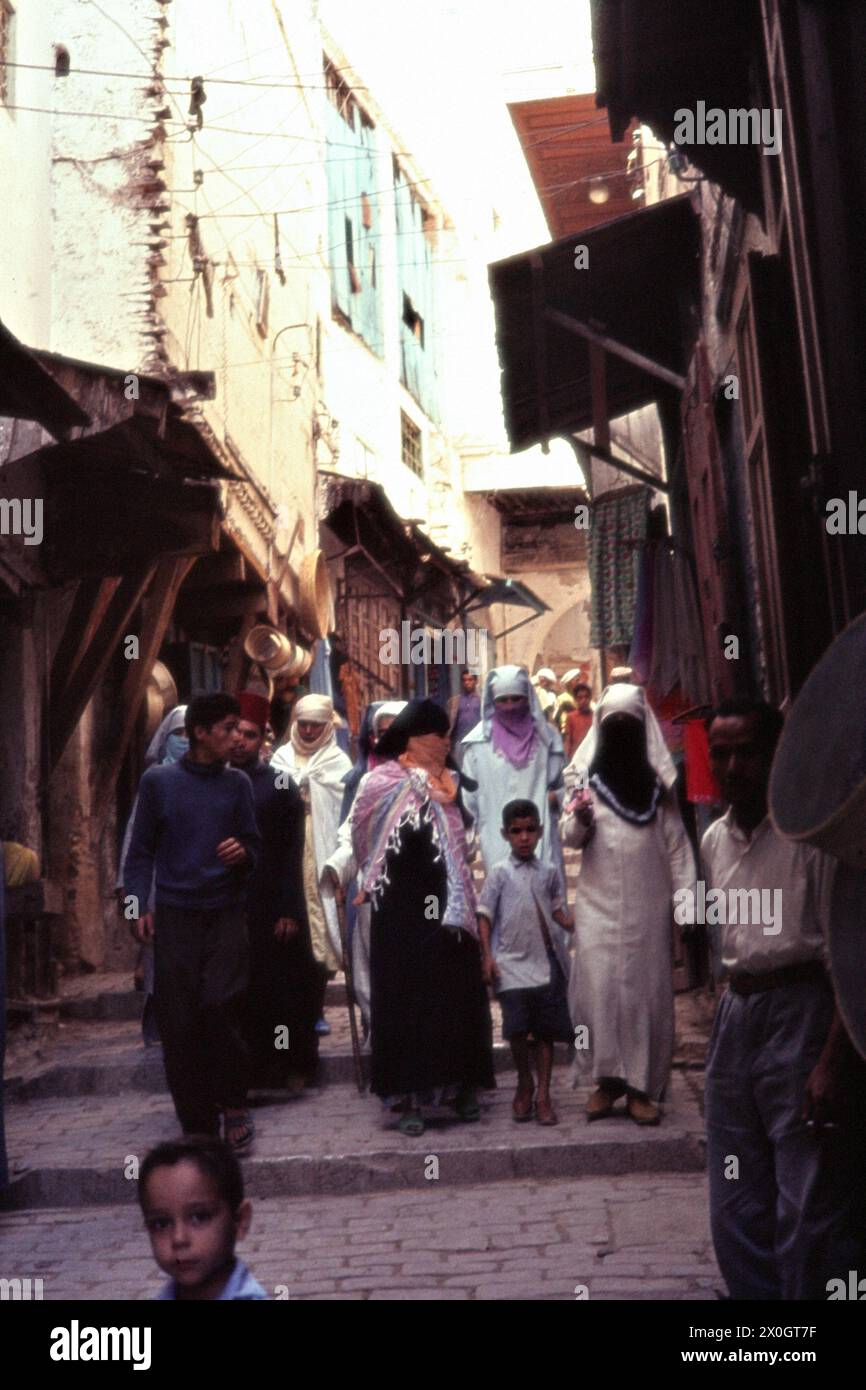A Moroccan family in an alley in the Medina (old town) of Fez ...
