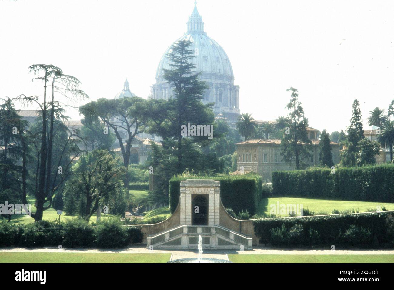 A fountain in the Pinacoteca with the dome of St. Peter's Basilica in ...