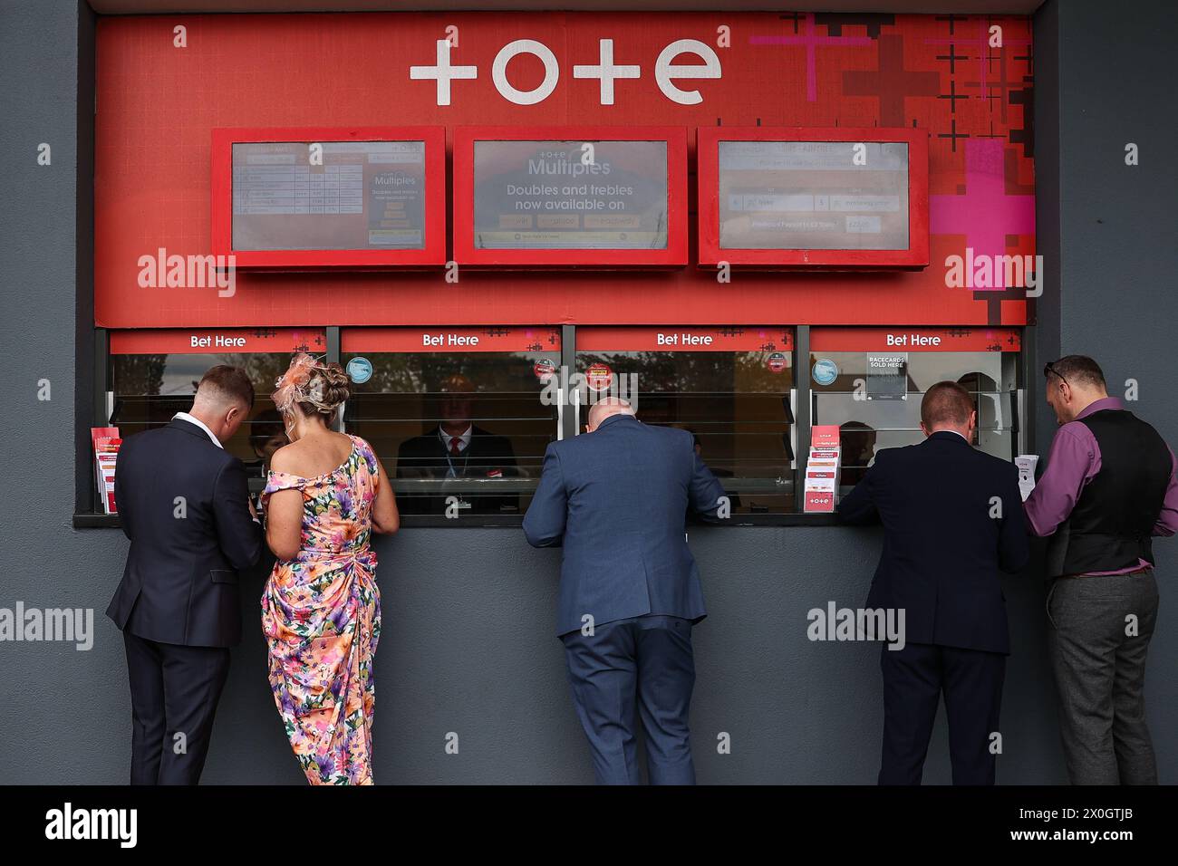 Racegoers place bets during the The Randox Grand National 2024 Ladies ...