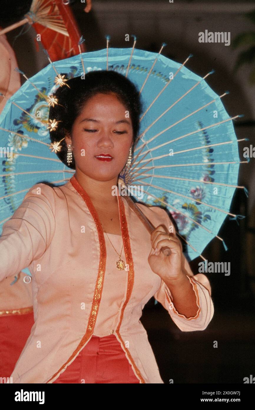 A Chinese Dancer With A Blue Umbrella And Hair Decoration During A Performance Of The Classical