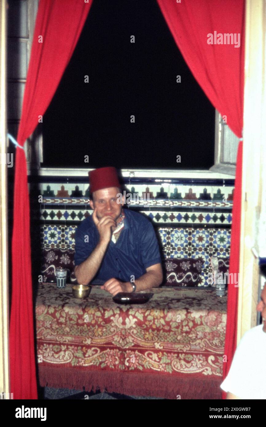 The photographer Czychowski poses with the traditional Moroccan hat Fez ...