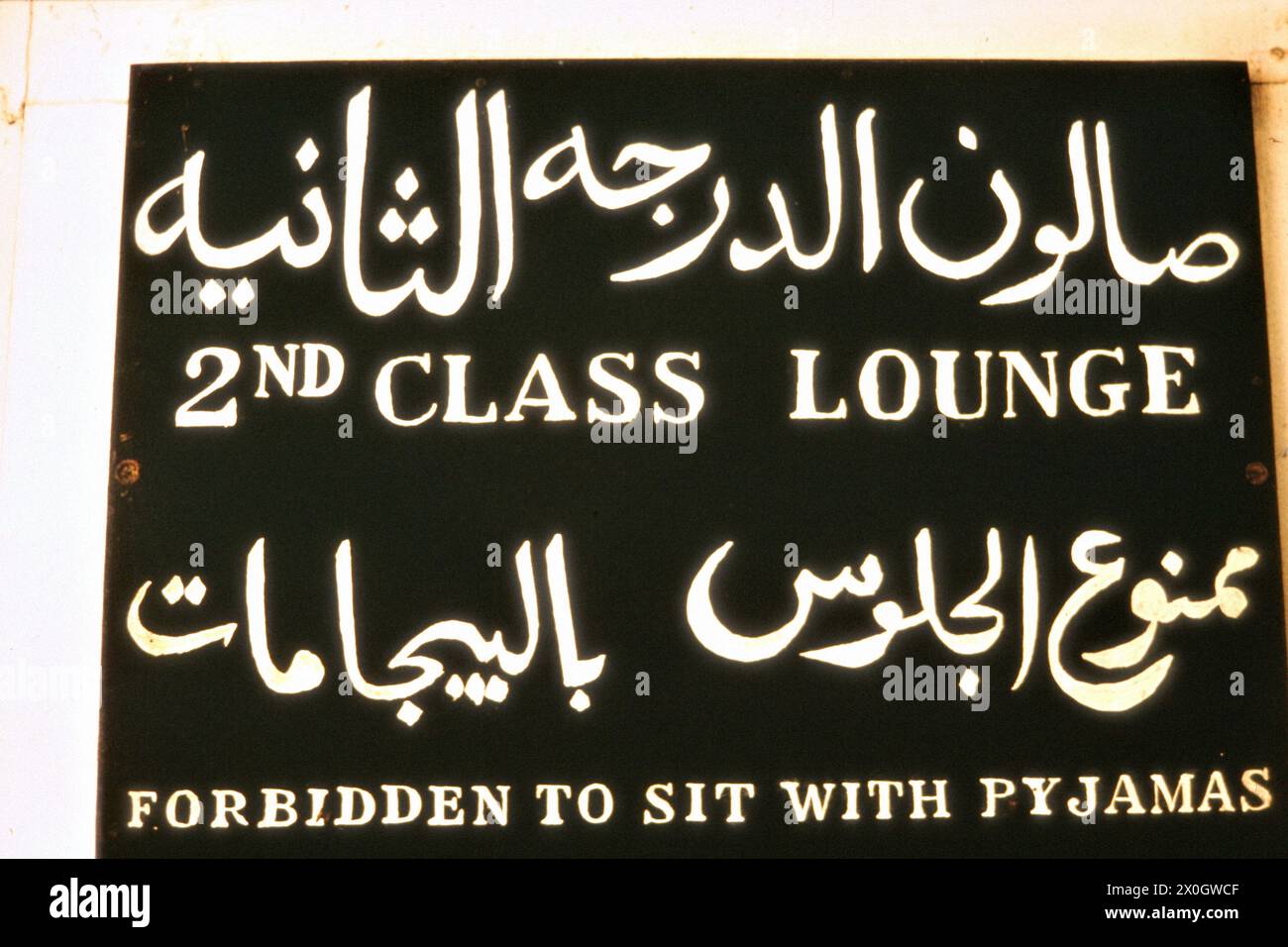 A prohibition sign with Arabic and English inscriptions informs ...
