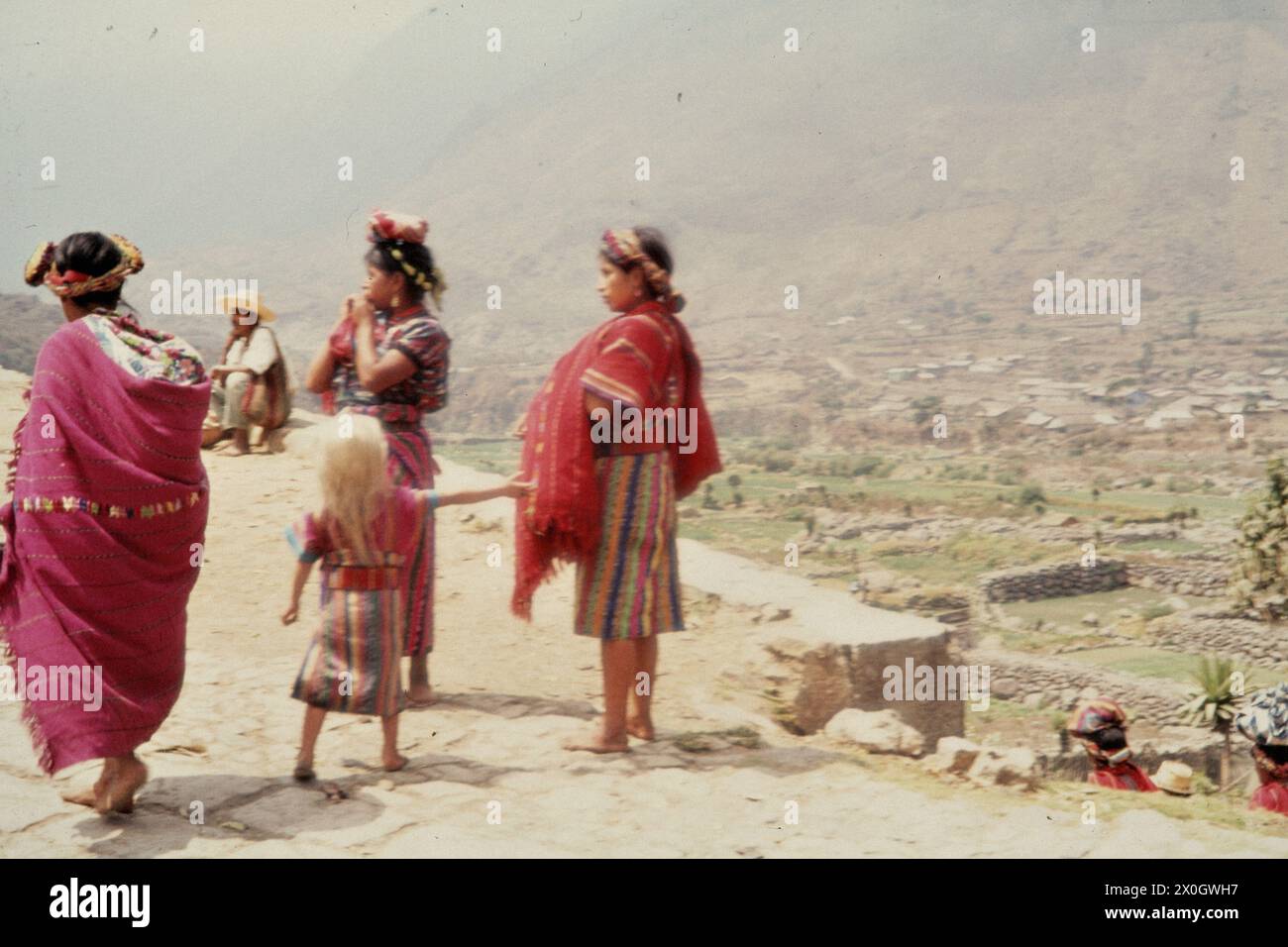 Quiché-Indio women and children in traditional costume in front of the ...