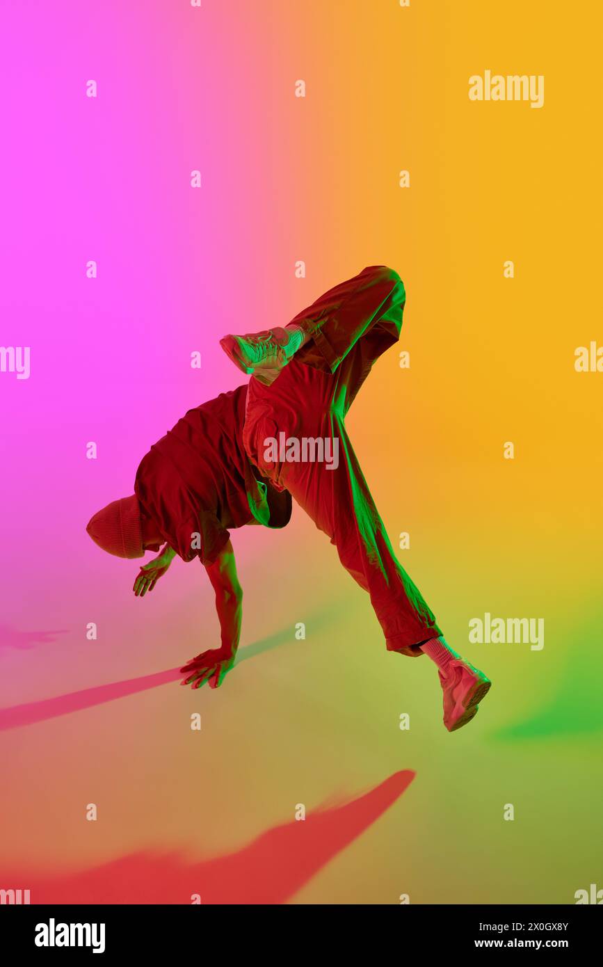 Dynamic photo of contemporary dancer in motion in neon light against ...
