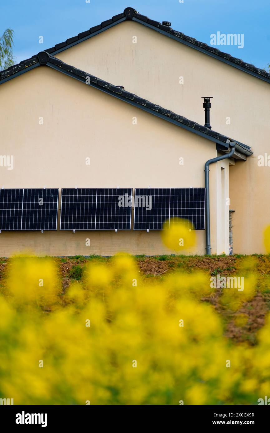 Solar panels on a well-exposed wall of an individual house, making ...