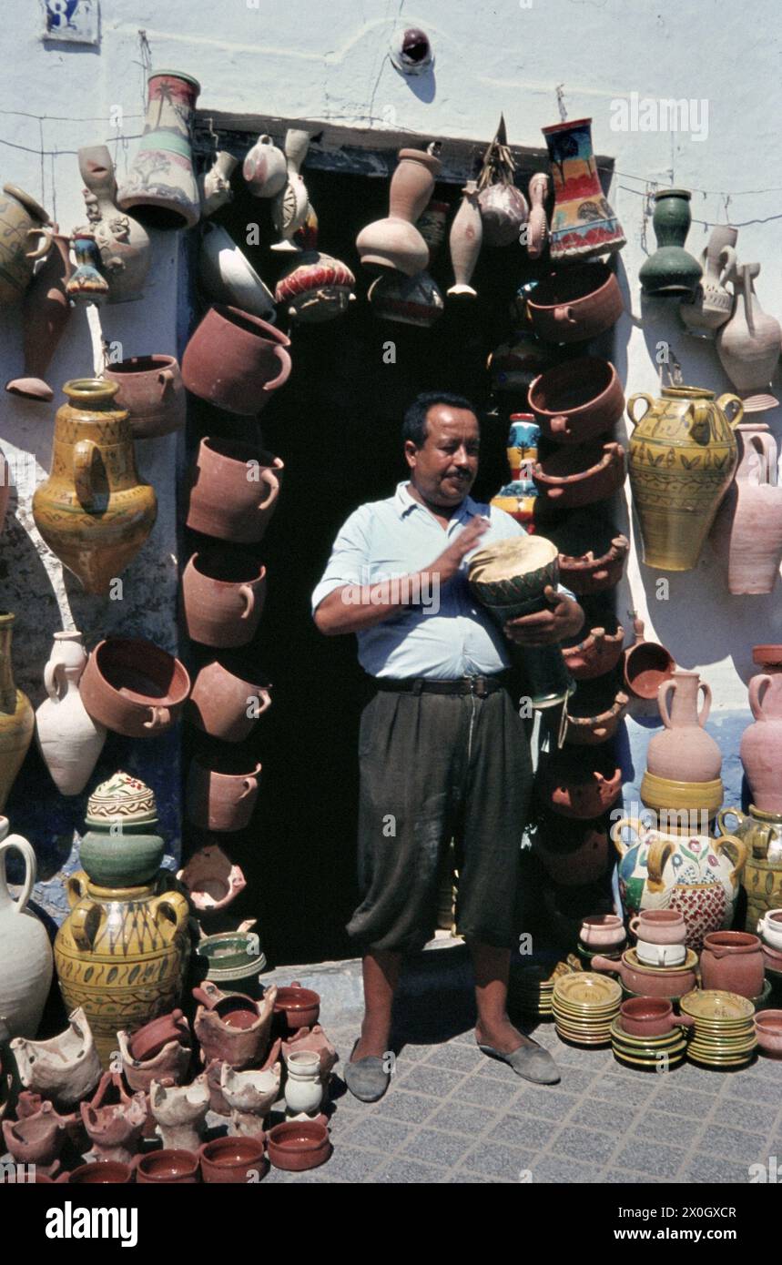 A man sells clay pots in a shop in Nabeul. [automated translation ...