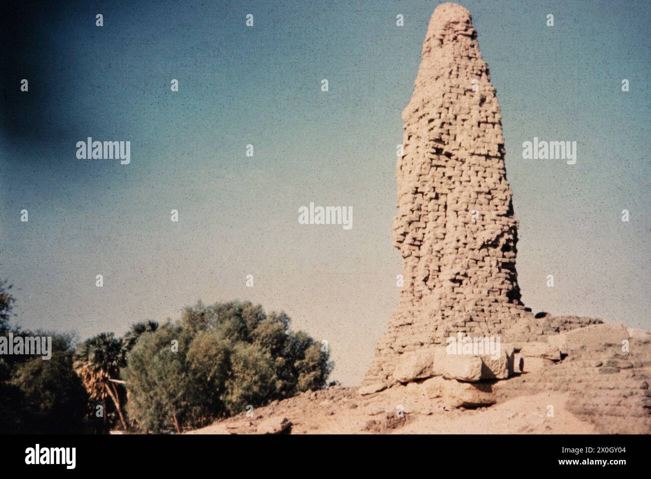 An ancient Egyptian obelisk made of Nile mud in the ruins of a temple ...
