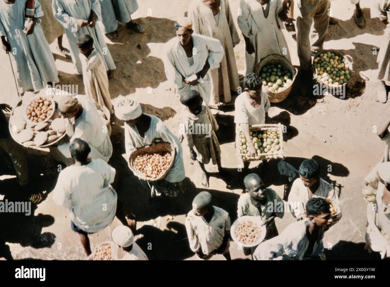 Children sell fruit and vegetables in a Nubian market place. [automated ...