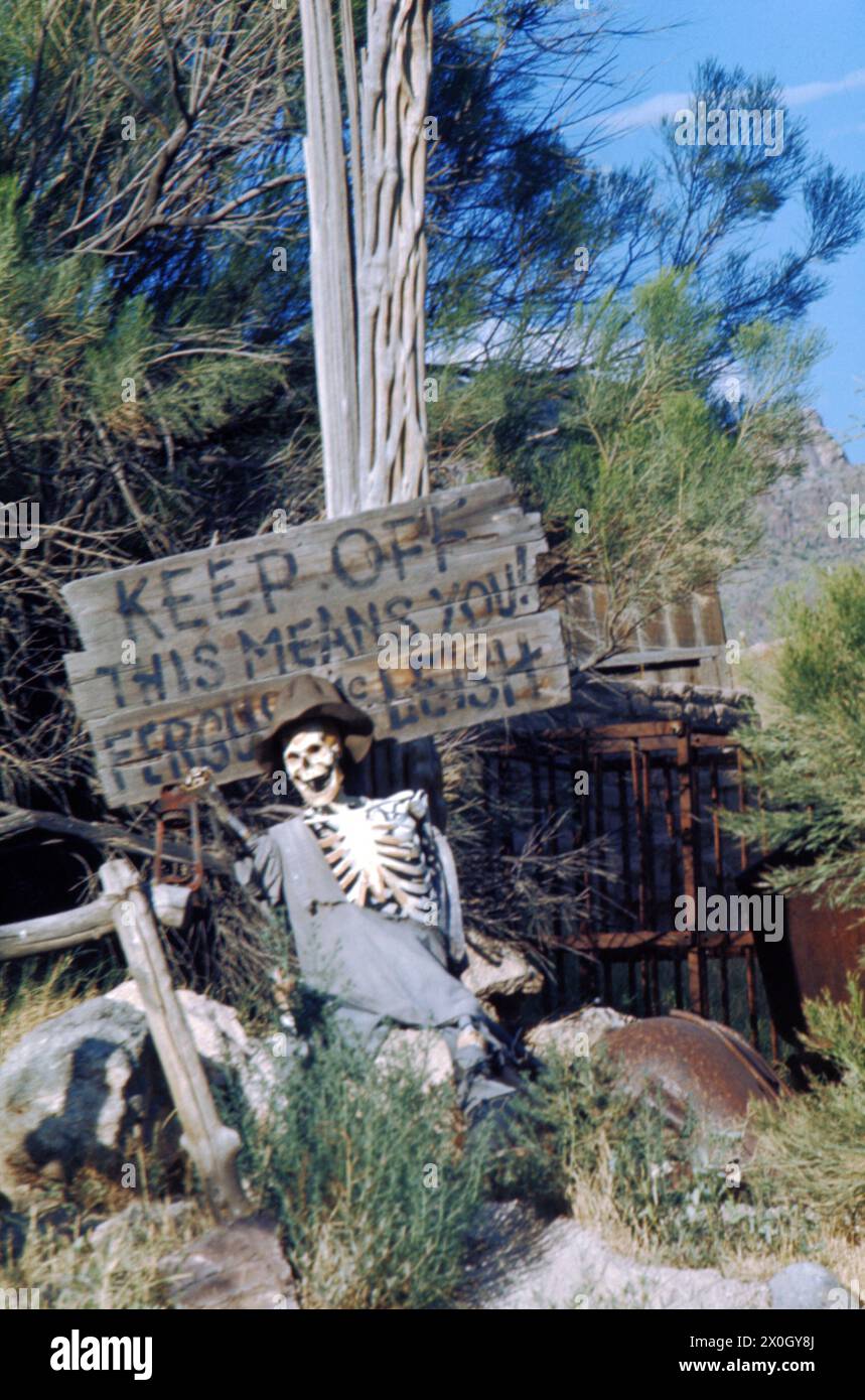 Skeleton and warning sign in the movie set of a western town in Old ...