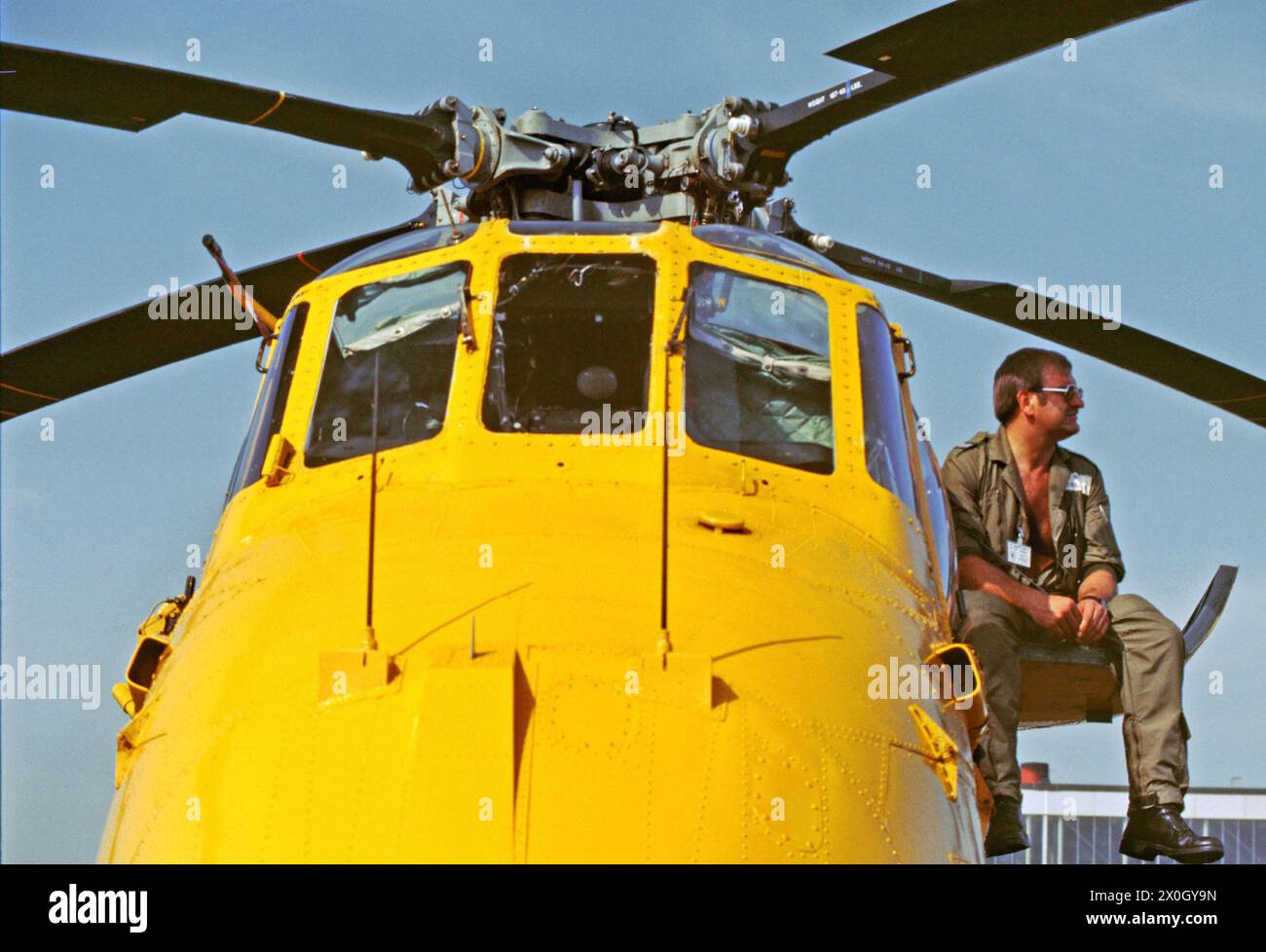 The pilot sits on his yellow Bundeswehr helicopter at the air show in ...