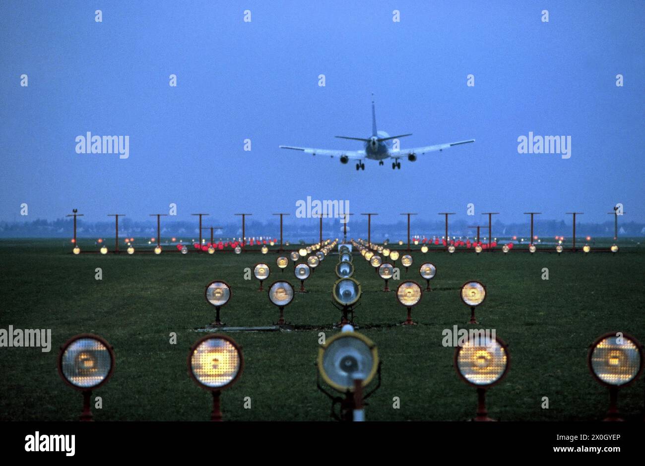 Landing of an aircraft at night on the Munich-Riem Airport (View from ...