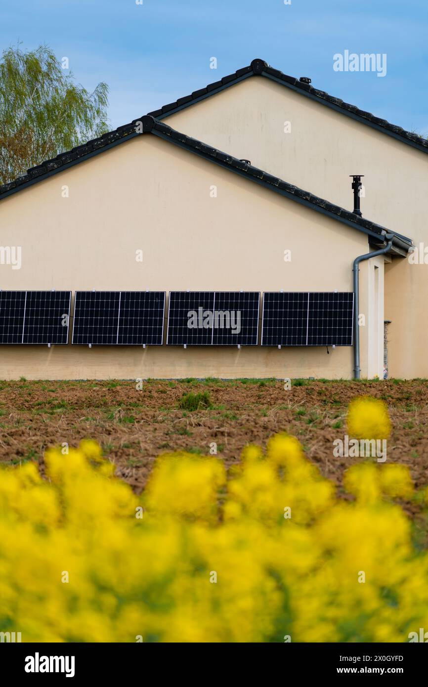 Solar panels on a well-exposed wall of an individual house, making ...