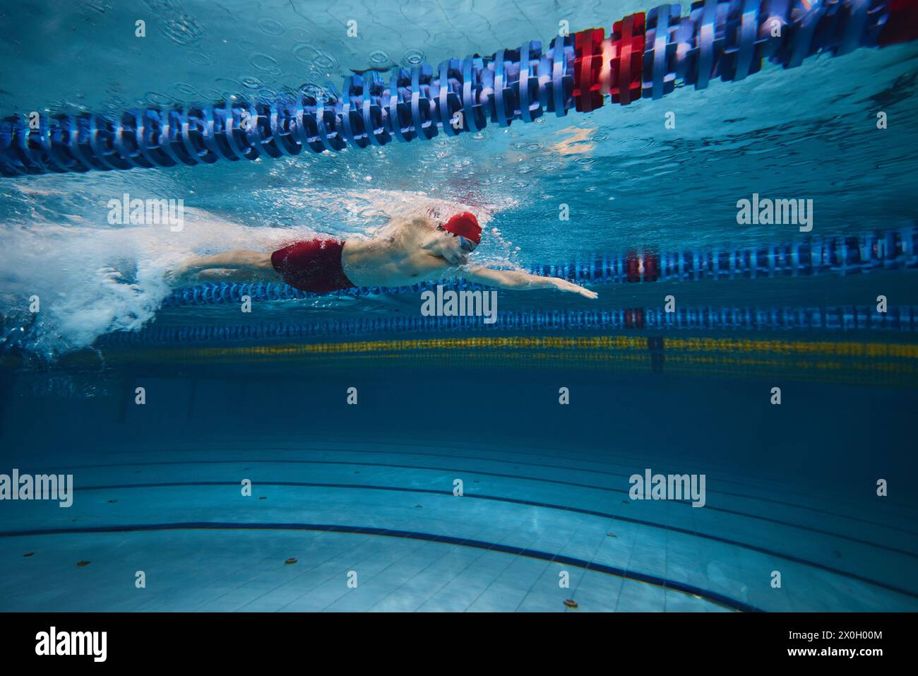 Boundless energy and motivation. Athletic young man, swimmer in cap and ...