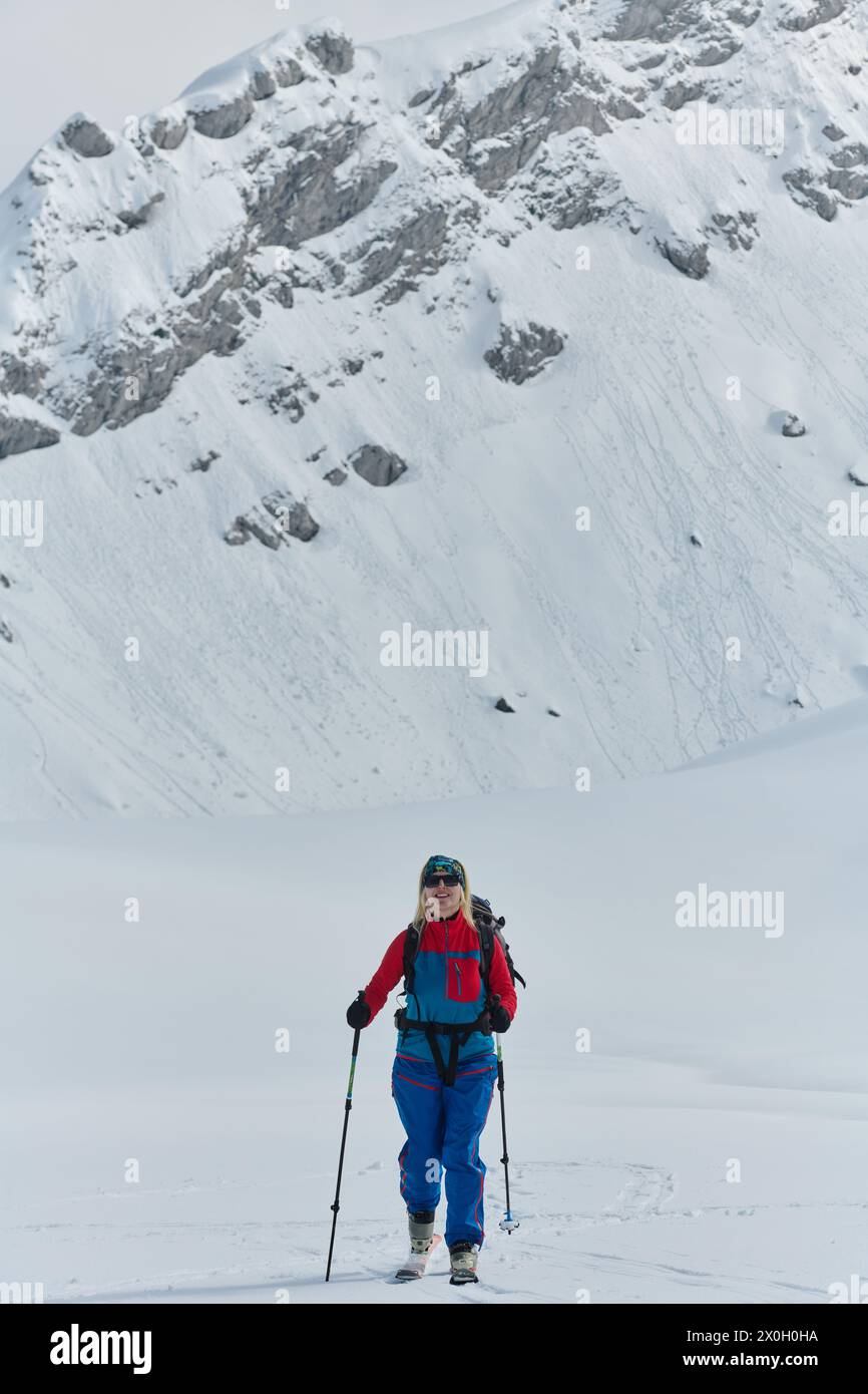A Female Mountaineer Ascends the Alps with Backcountry Gear Stock Photo ...
