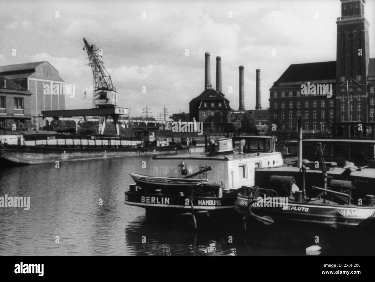 The Berlin Westhafen with ships and a crane. On the right there is the ...