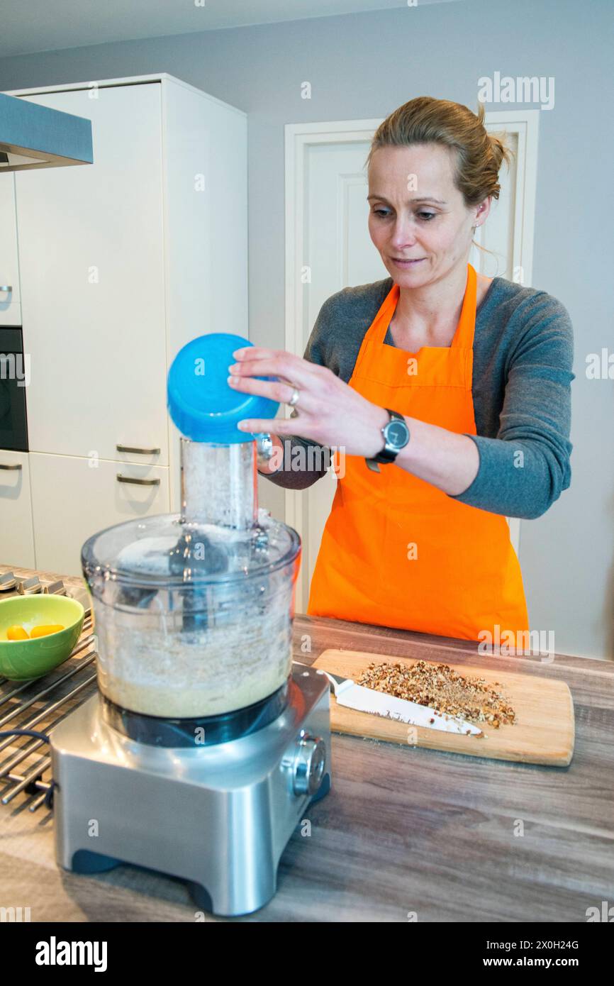 Housewife and Mother Baking a Cake Mid adult caucasian woman preparing ...