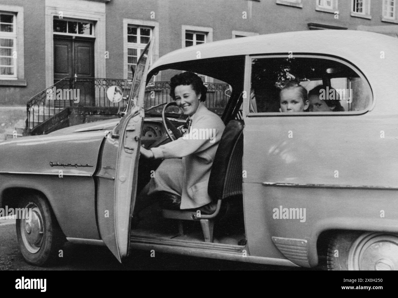 A proud car owner with kids on the back seat in the Sauerland Stock ...