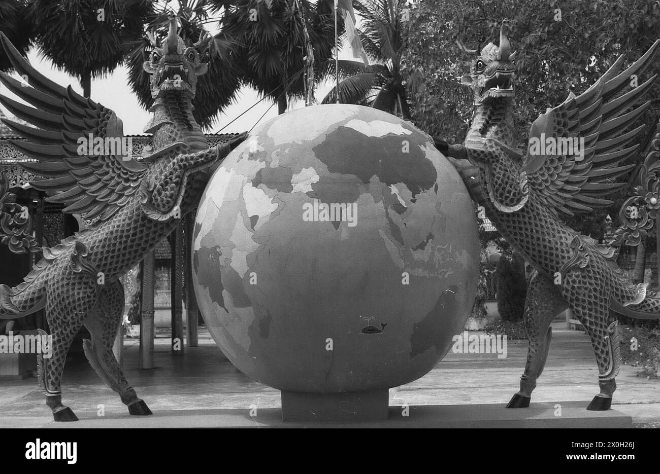 Two dragon sculptures with wings holding a globe in Penang in Malaysia ...