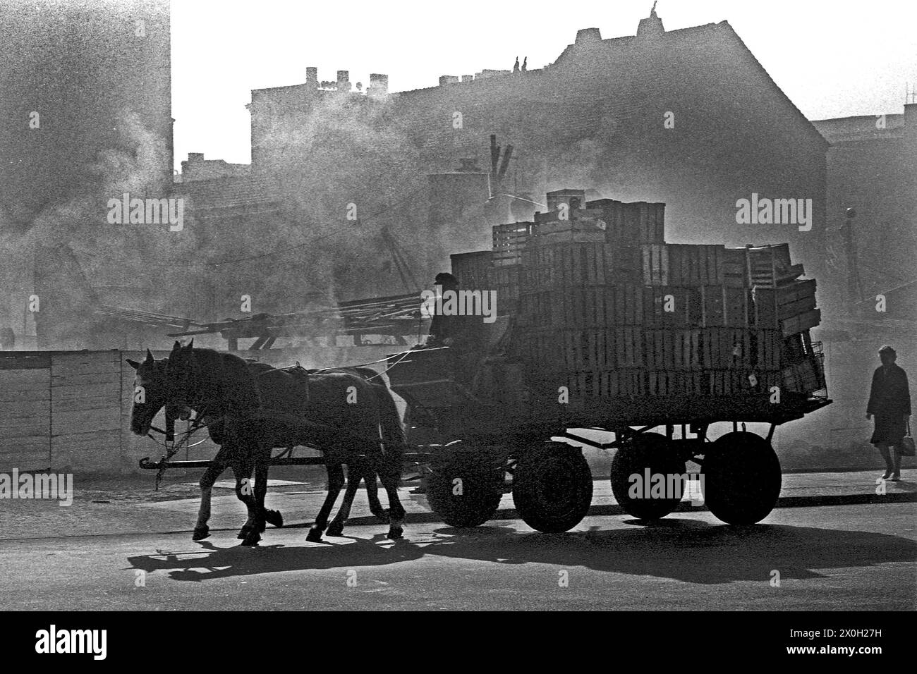 A heavily loaded cart is pulled by horses in East Berlin Stock Photo ...