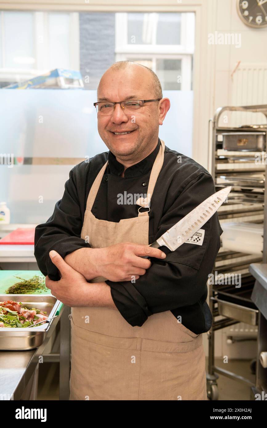 Chef preparing Take Away Food Mid adult male chef busy with his mise-en ...