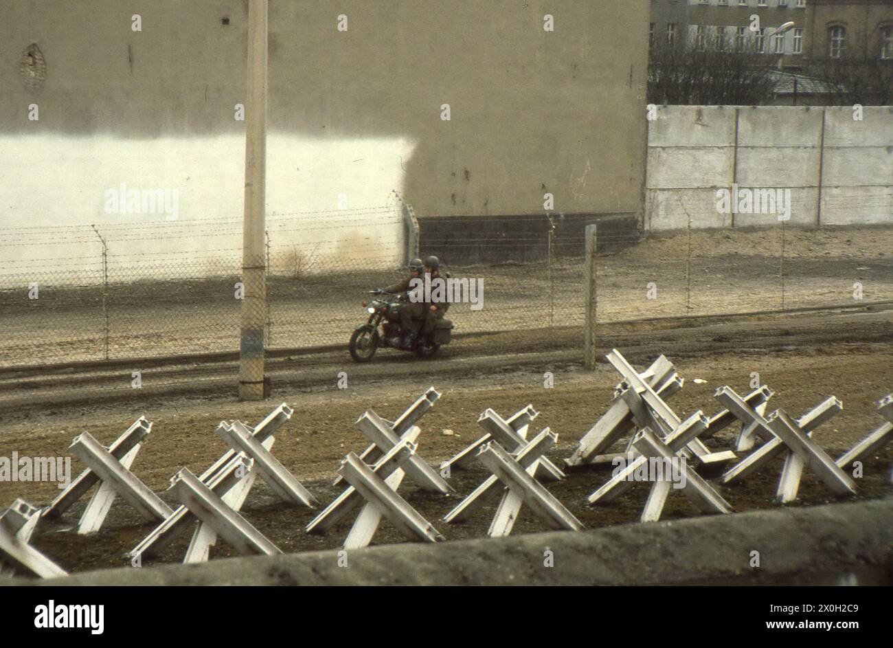 East German border guards on a motorbike ride along the border. In the ...