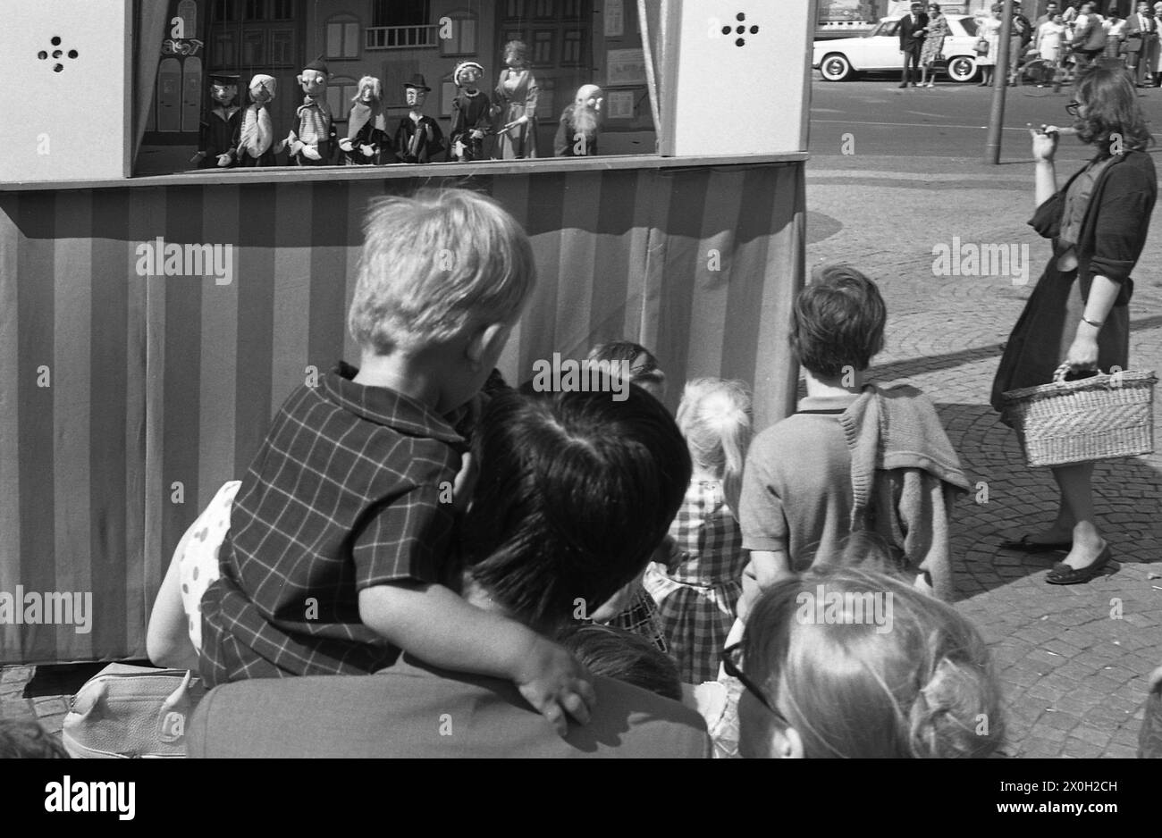 Children watch a puppet theater in Amsterdam. The individual puppet ...