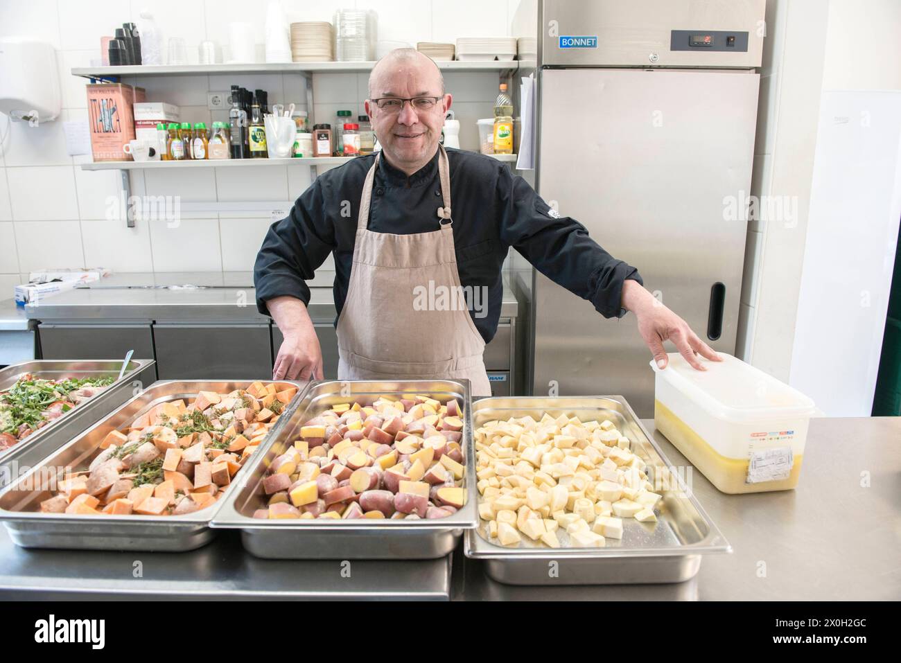 Chef preparing Take Away Food Mid adult male chef busy with his mise-en ...