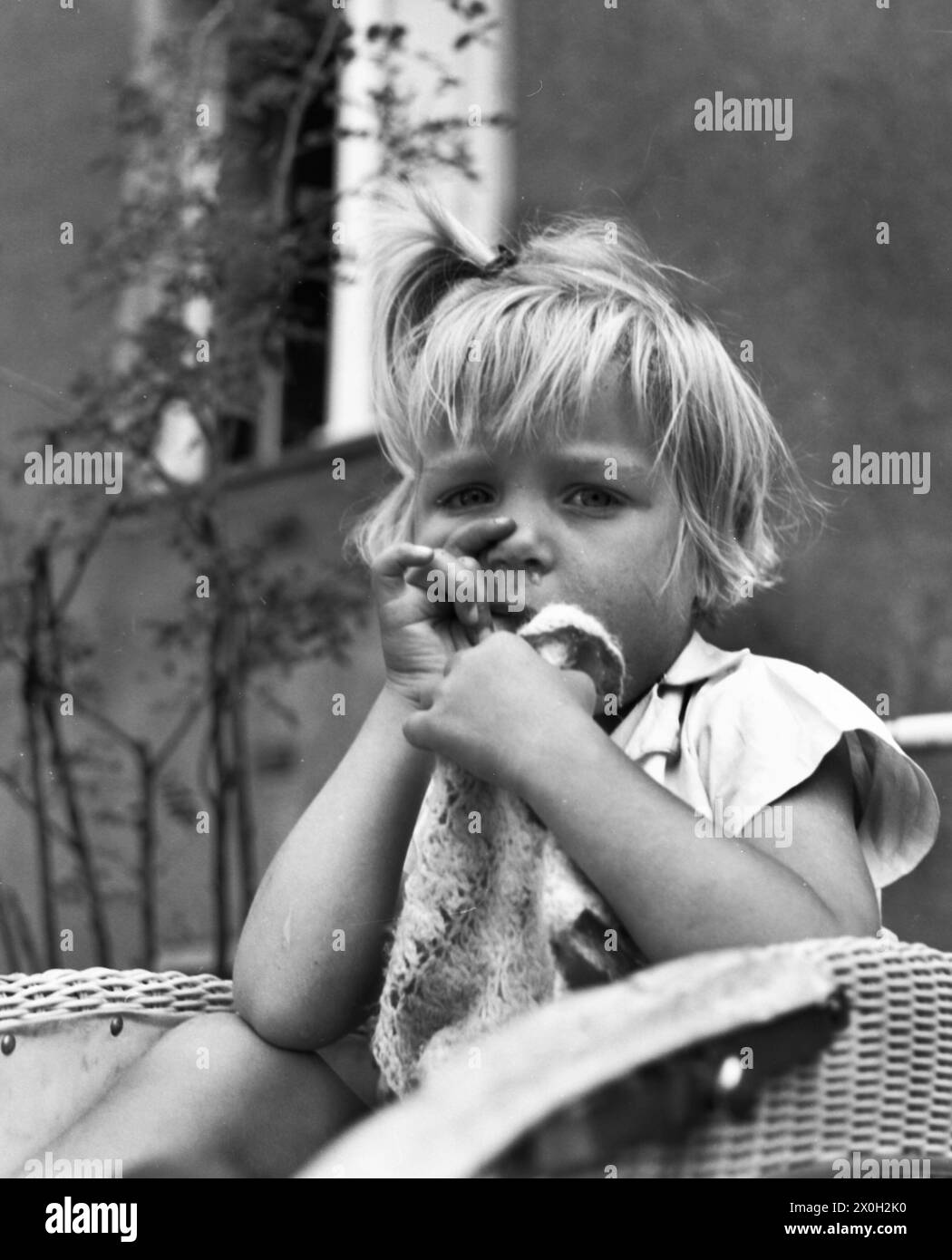 A little girl sits sadly and crying in her baby carriage. [automated ...