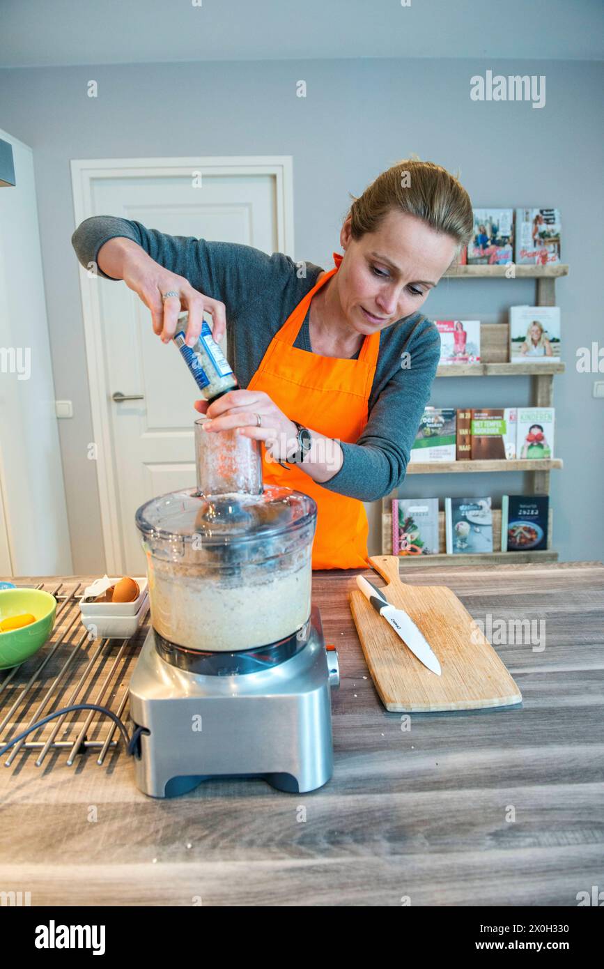 Housewife and Mother Baking a Cake Mid adult caucasian woman preparing ...