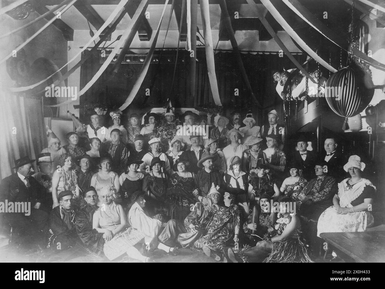 The visitors to a carnival ball line up for a group photo. [automated ...