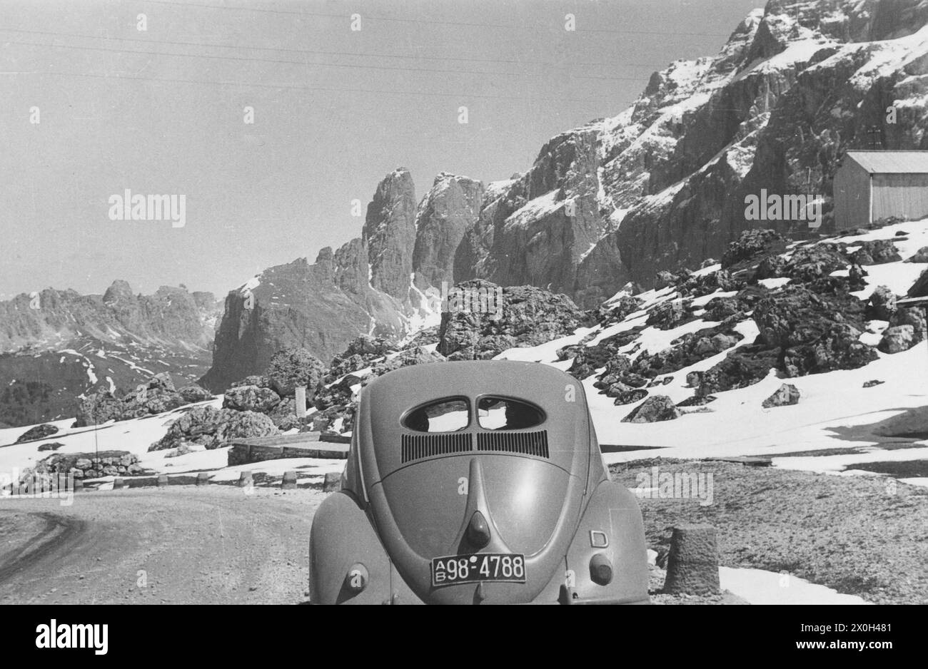 A car drives along a road in the Dolomites. [automated translation ...