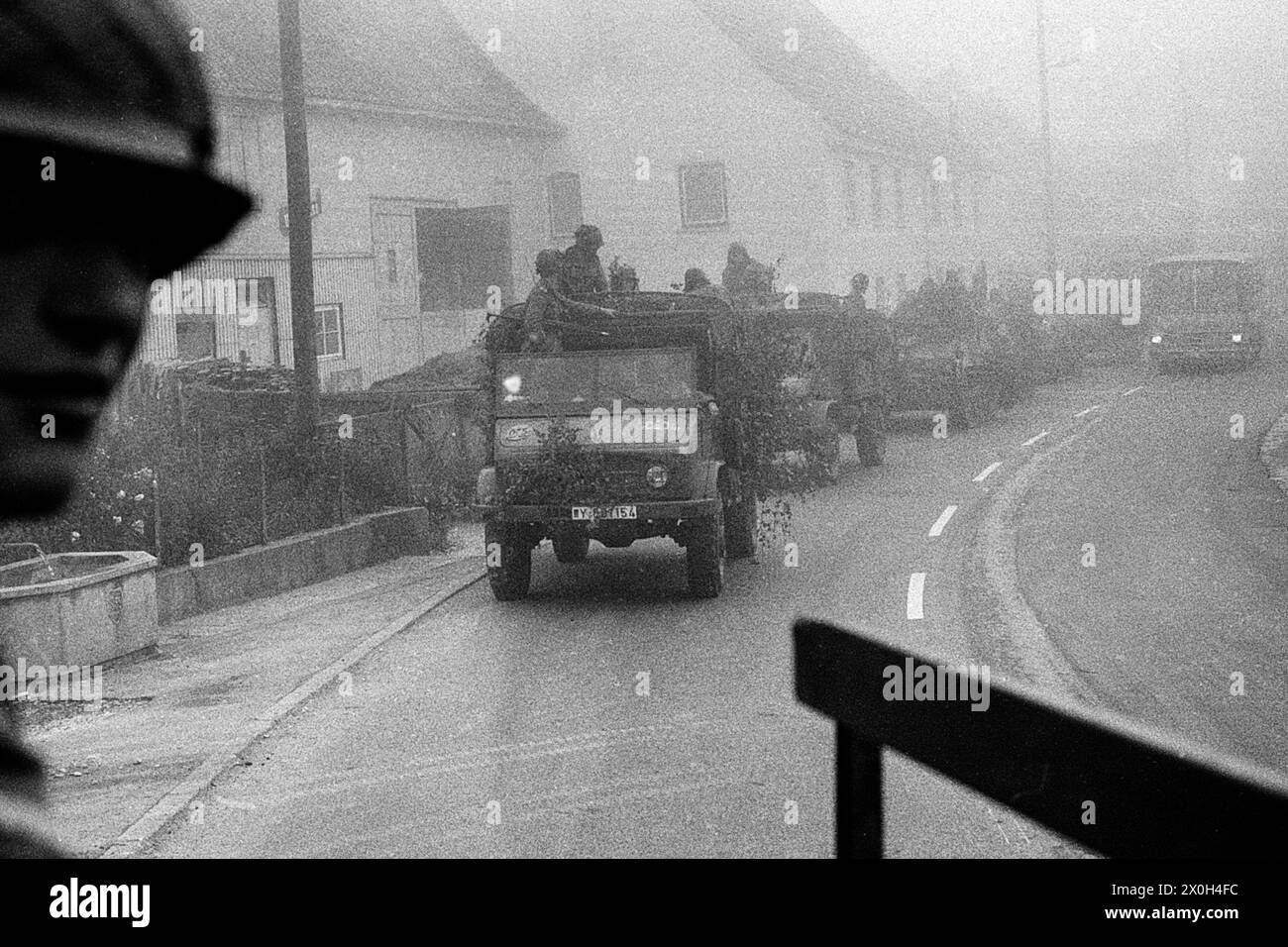 A school bus overtakes a convoy of Bundeswehr vehicles during a combat ...