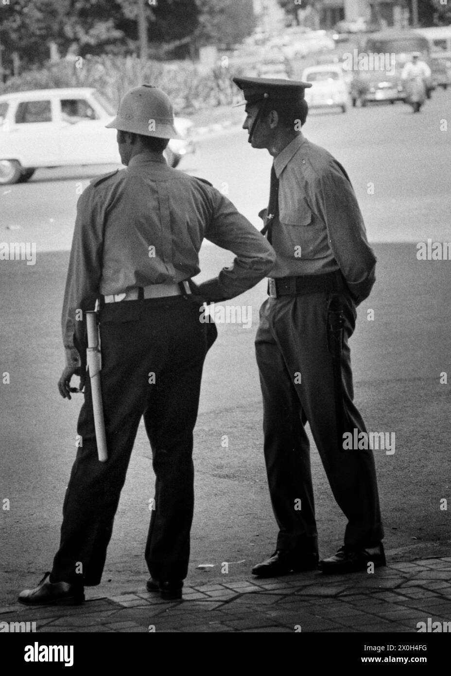 Two Spanish police officers in Madrid. The one on the left is wearing a ...