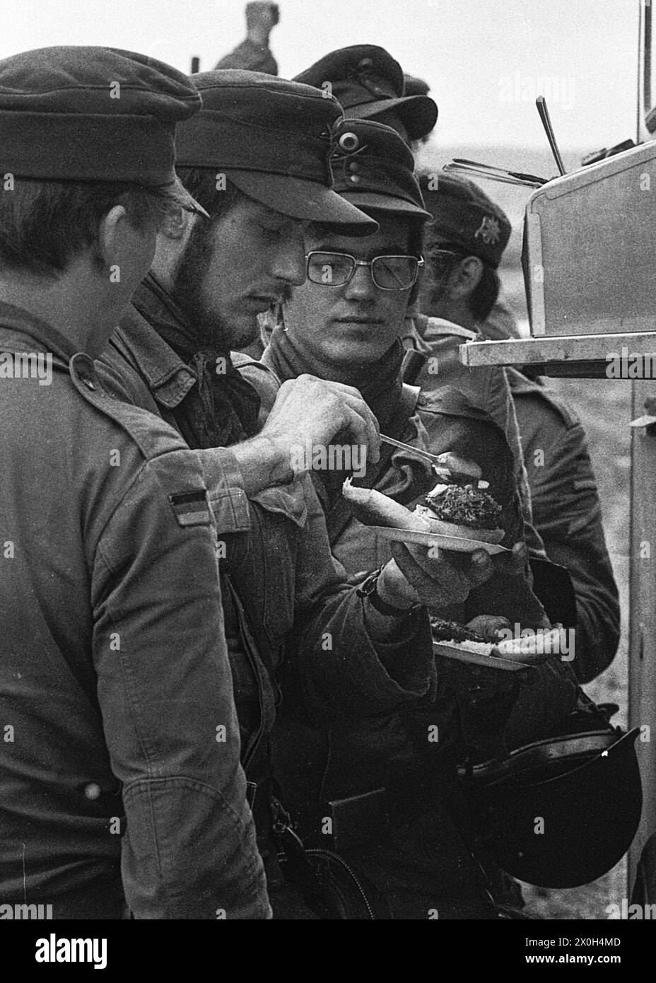 Troop exercise: Soldiers fill their hamburgers. A supply truck delivers ...