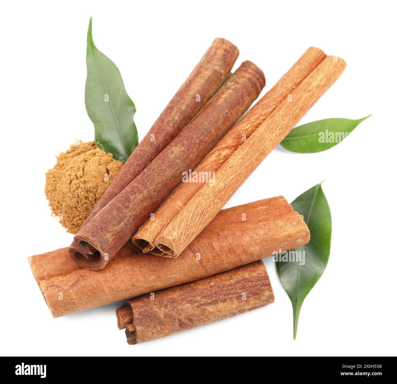 Dry aromatic cinnamon sticks, powder and green leaves isolated on white ...