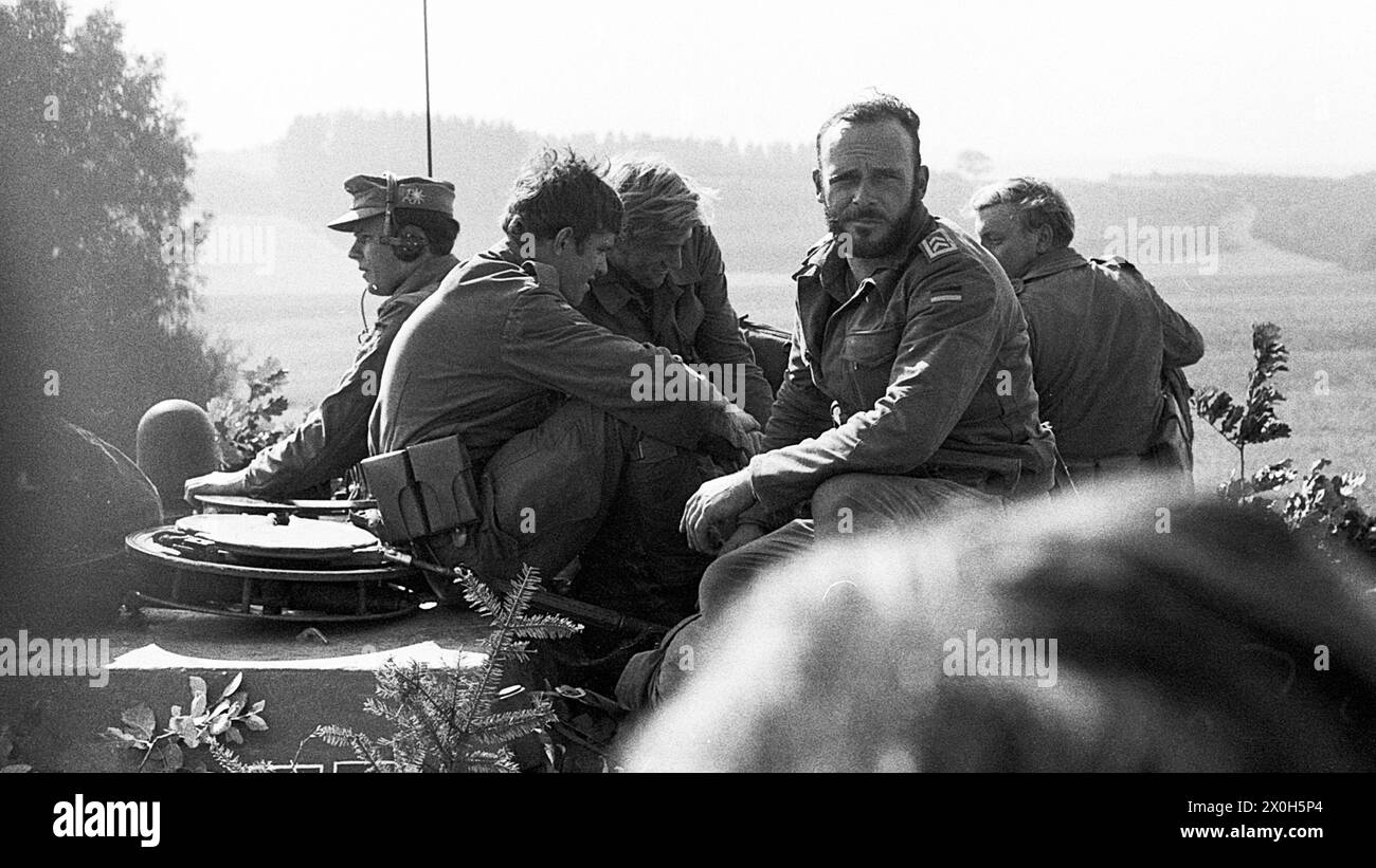 A group of soldiers sits on a tank during a Bundeswehr combat exercise ...